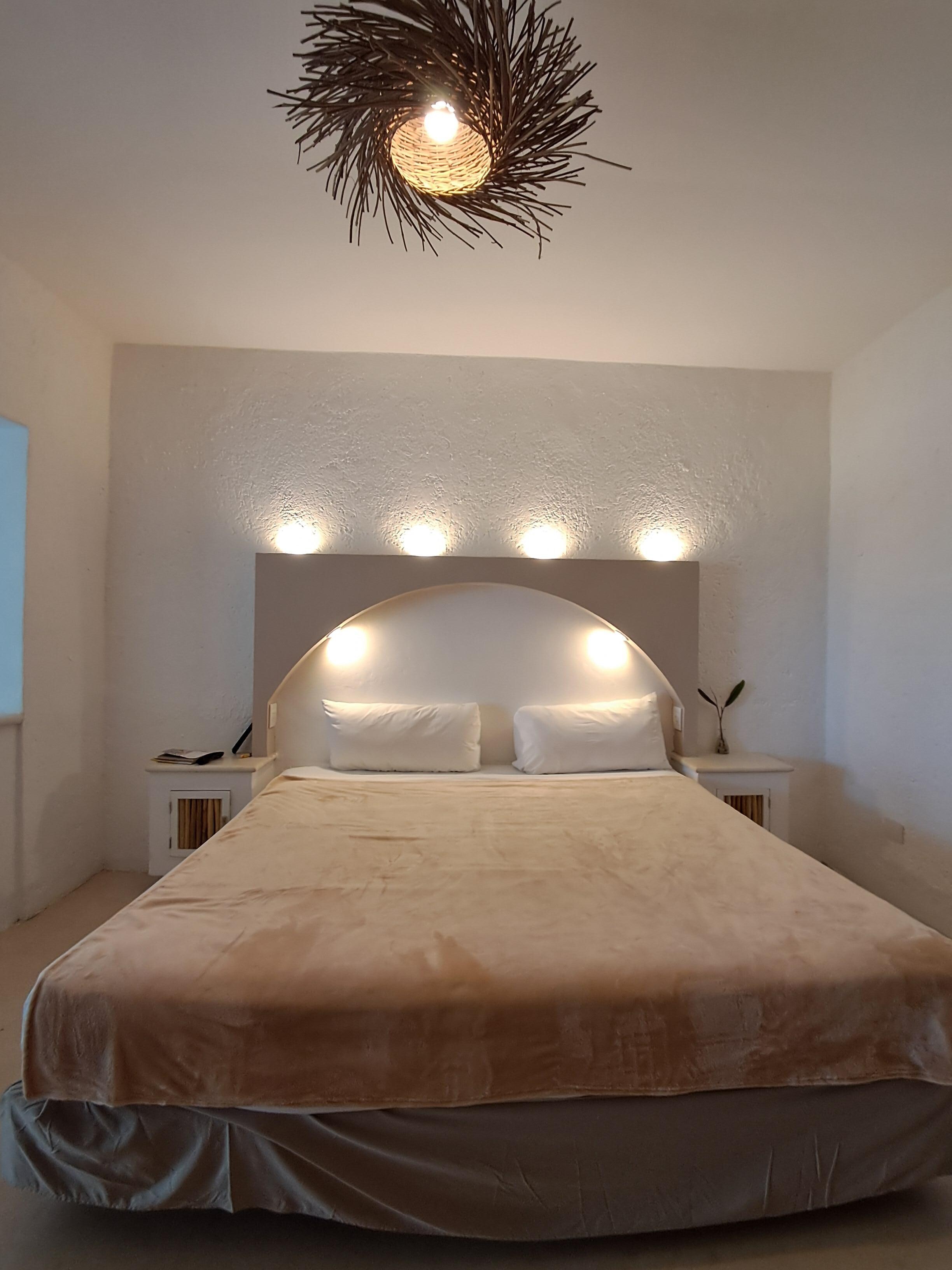Room with queen bed and twin. Fridge, tv.