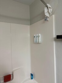 Towel from previous guest still hanging in the shower.