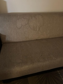 The sofa had dirty spots all over it.