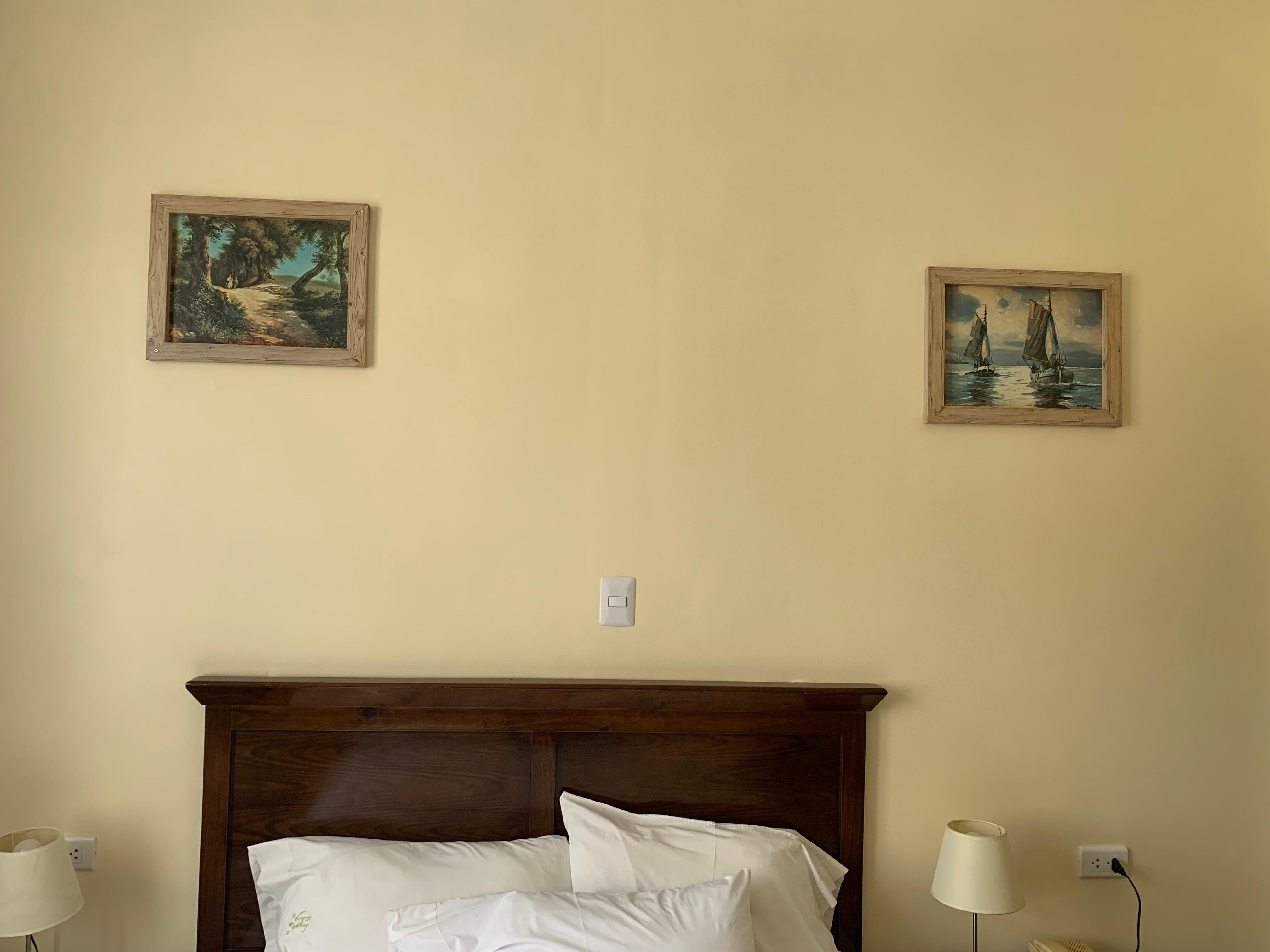 Wall art carelessly attached to wall.  