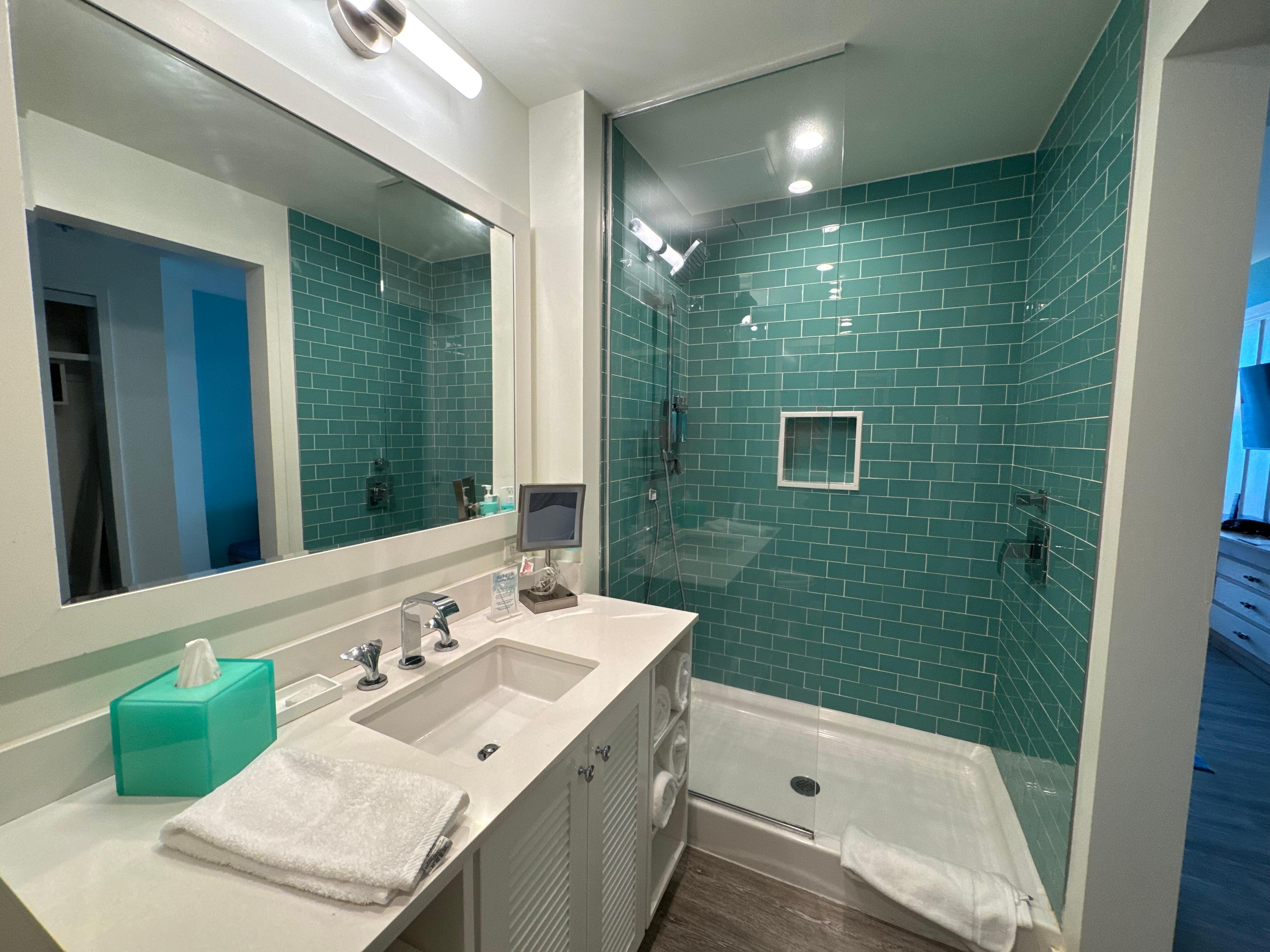 Stylish bathroom. Love the mermaid hand faucet details. I wish there was a lower seat/shelf to put my foot/leg to wash or shave. 