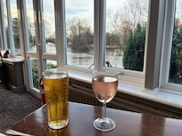 Drinks in the bar overlooking the (very high) river….
