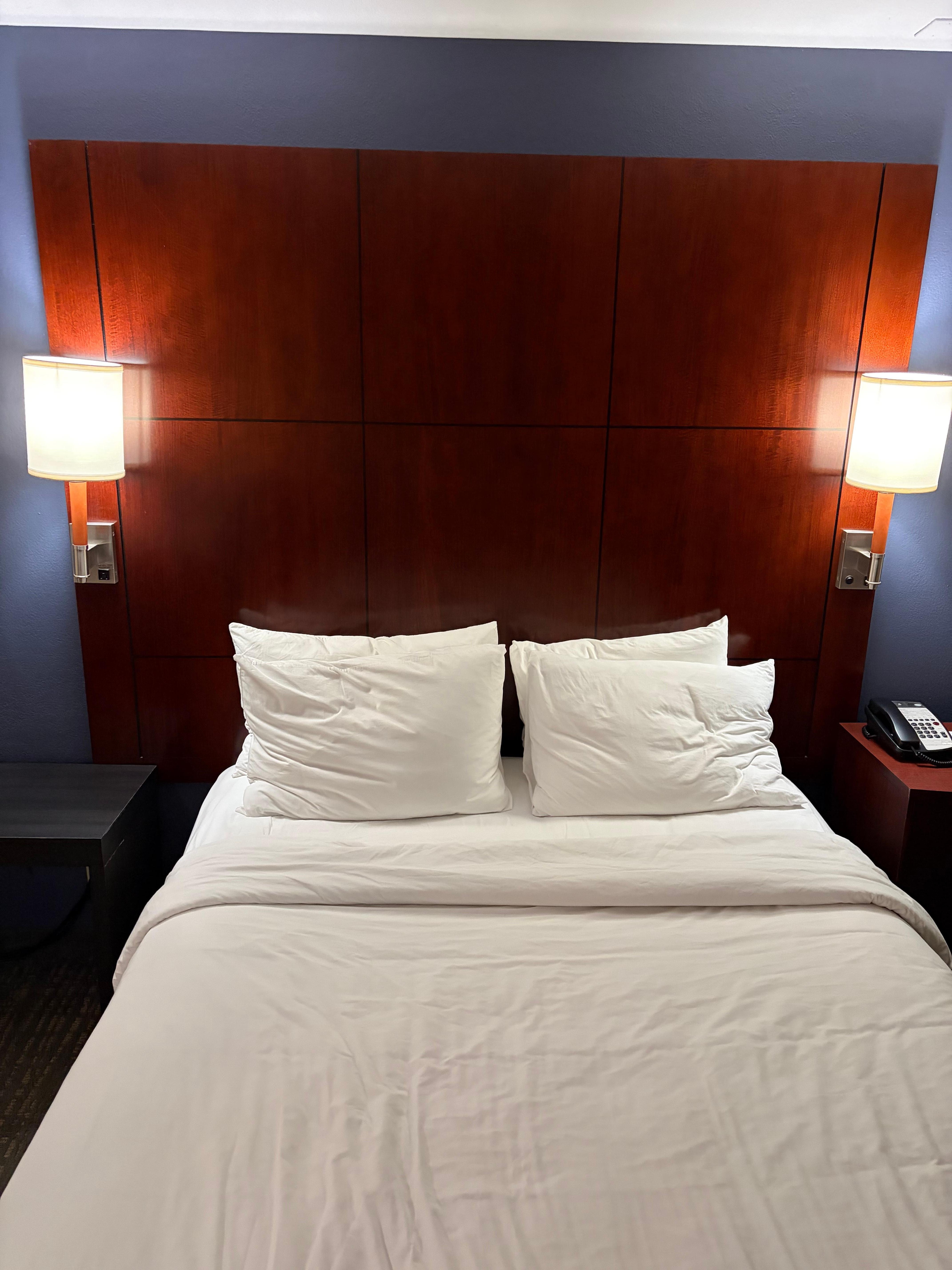 You can see the headboard is made for a king size bed and the mattress is much smaller.