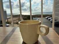 Having coffee on the balcony.