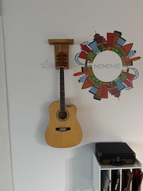 Guitar for guest use and record player!  Nice touch.