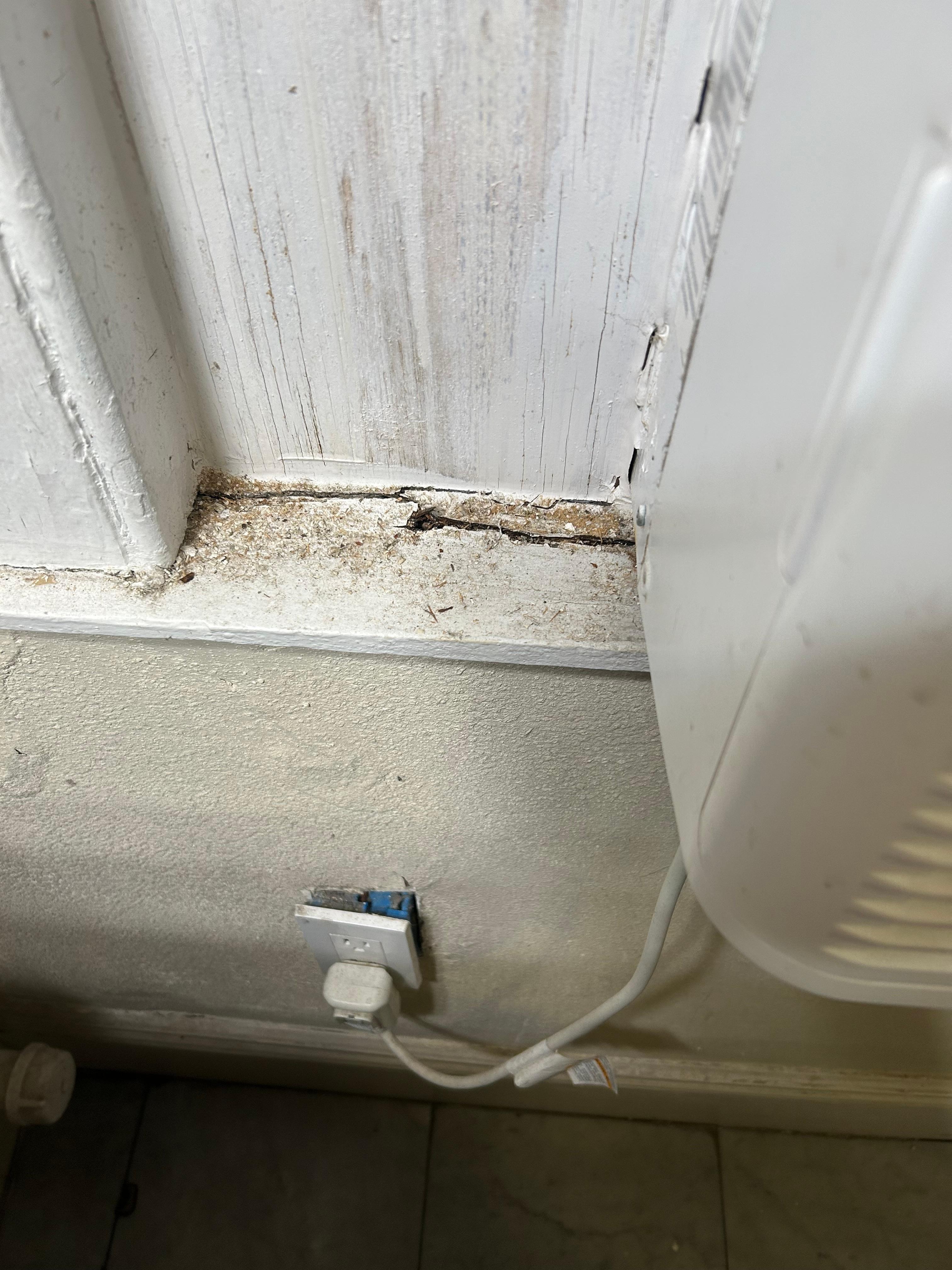 Dirty windowsill and plug falling out of the wall