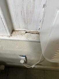 Dirty windowsill and plug falling out of the wall