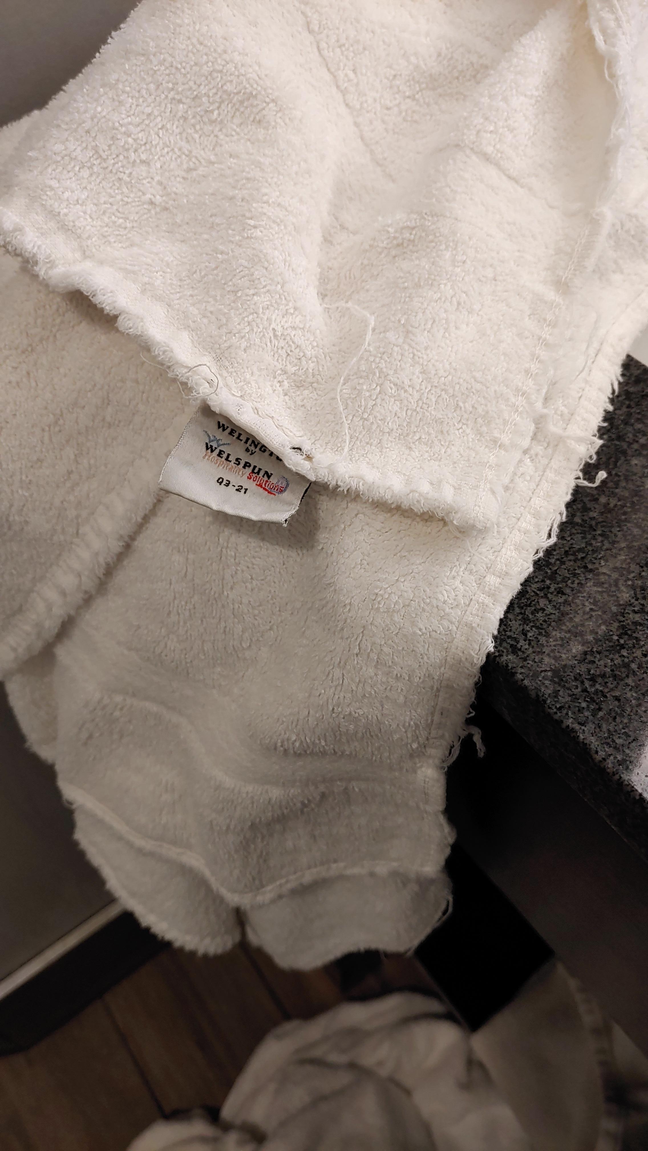 Very worn, dingy bath towel 