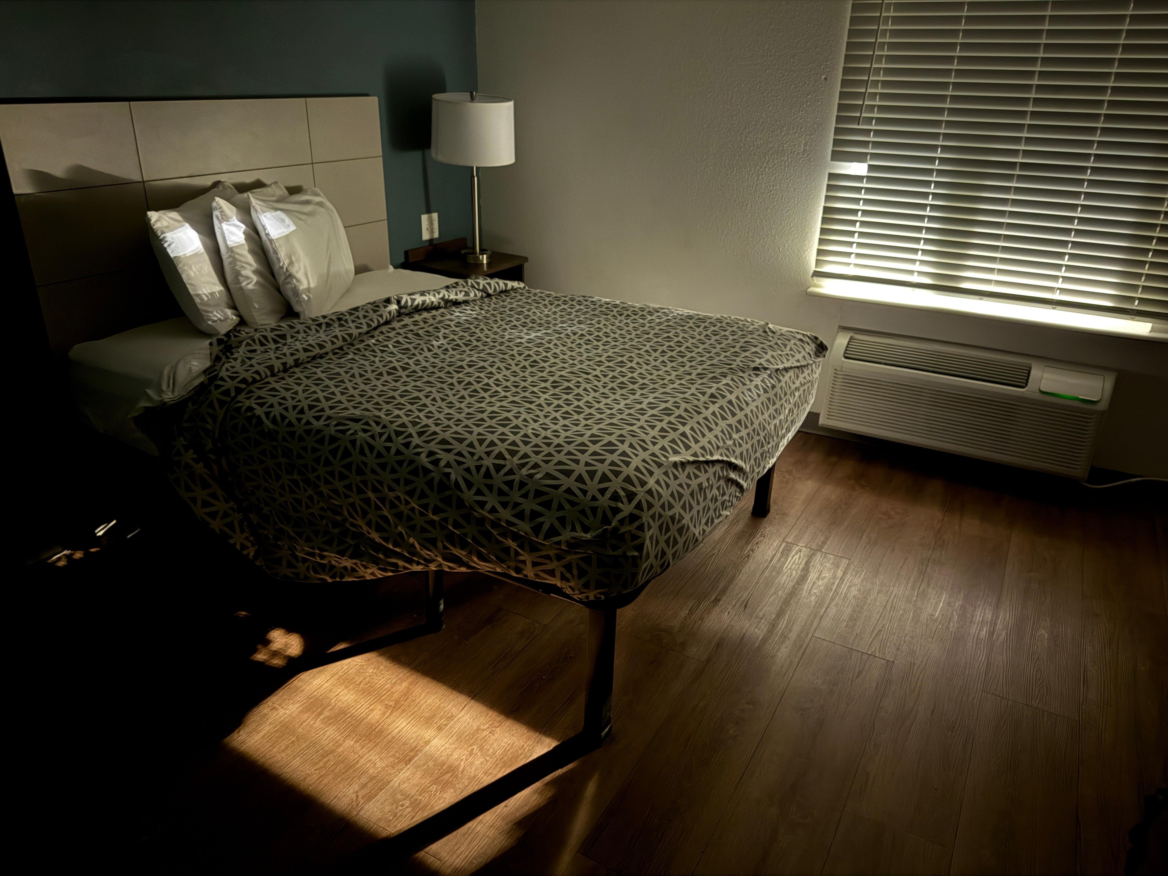 As dark as the room could get prior to 2am when the spotlight on the roof shut off. Note the paper-thin blanket.