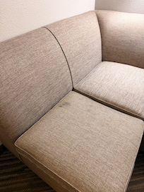 Stained sofa in the room. We tried turning some of the cushions over but that had already been done. These were the best sides. Yuck