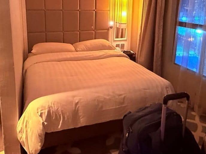 this is the room we got for 2 people. we had to alternate our luggage on the table in order to get something. then close it off so we could walk around in the room!