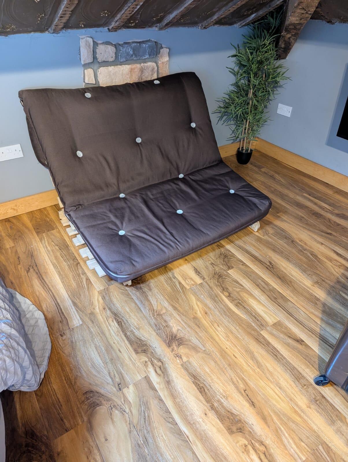 Cheapest futon but neatly put it in the bed to try and add some padding. 