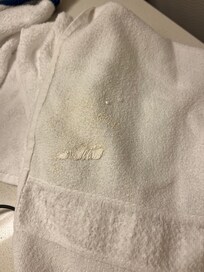 Towel with dried paint crusted on.