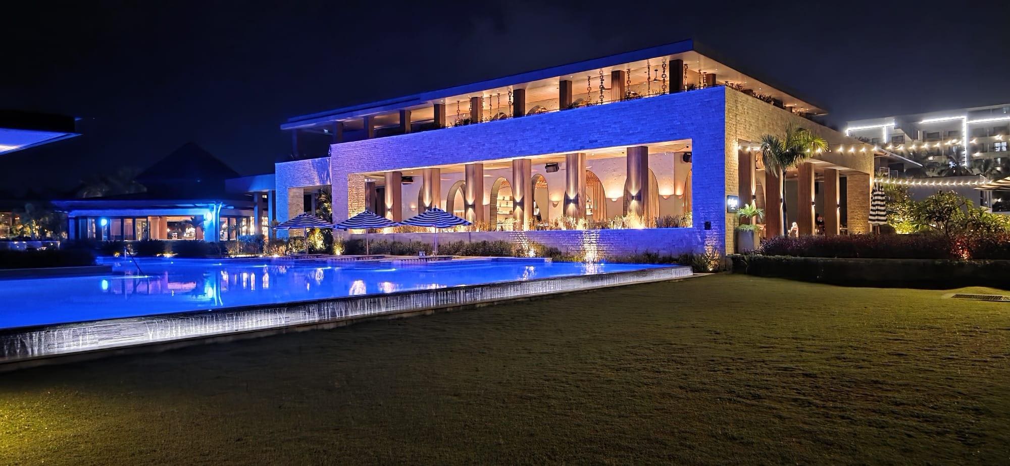 Beach side of hotel lit up at night