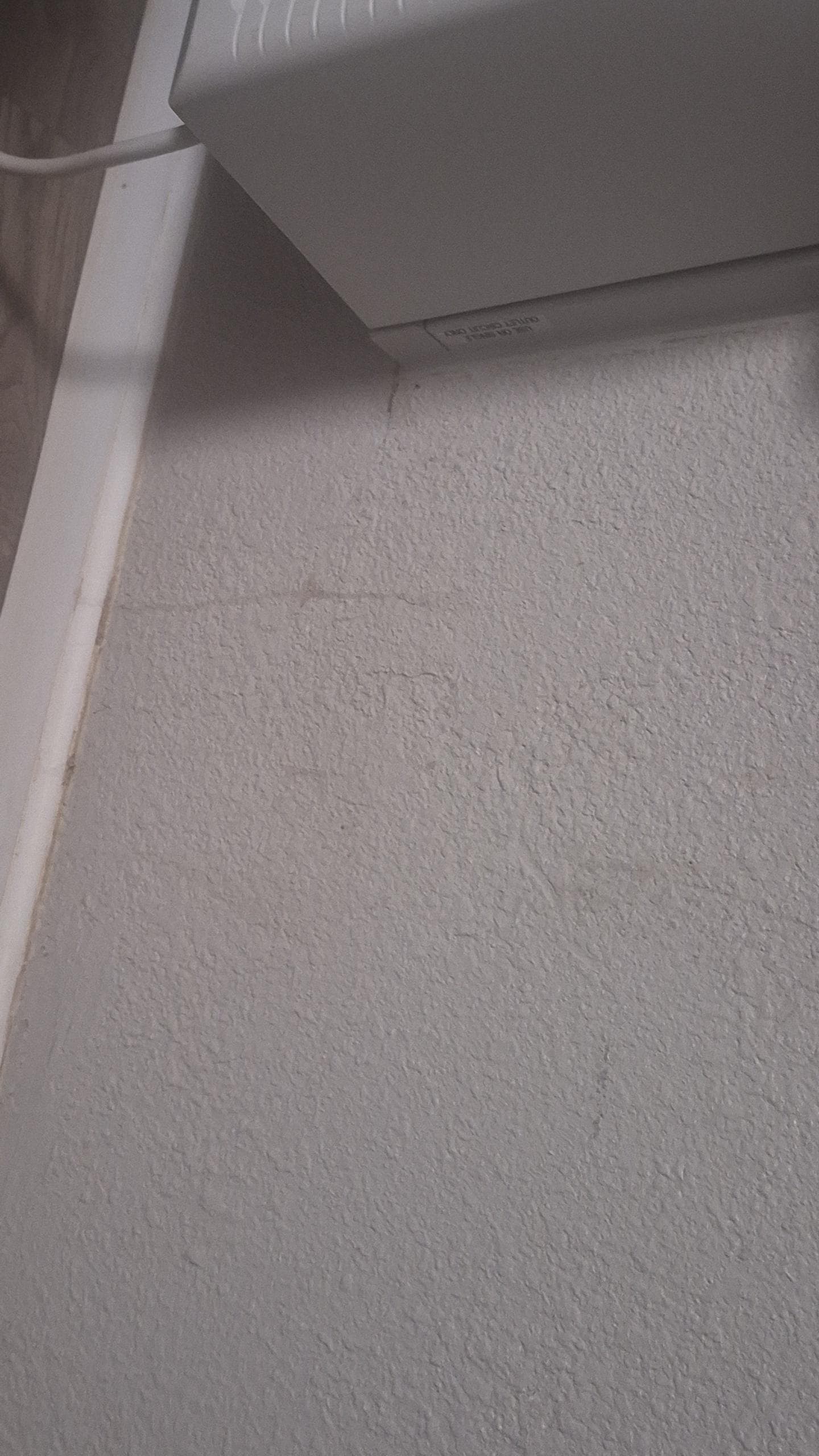 Stains all over the wall by the front door.