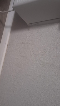 Stains all over the wall by the front door.