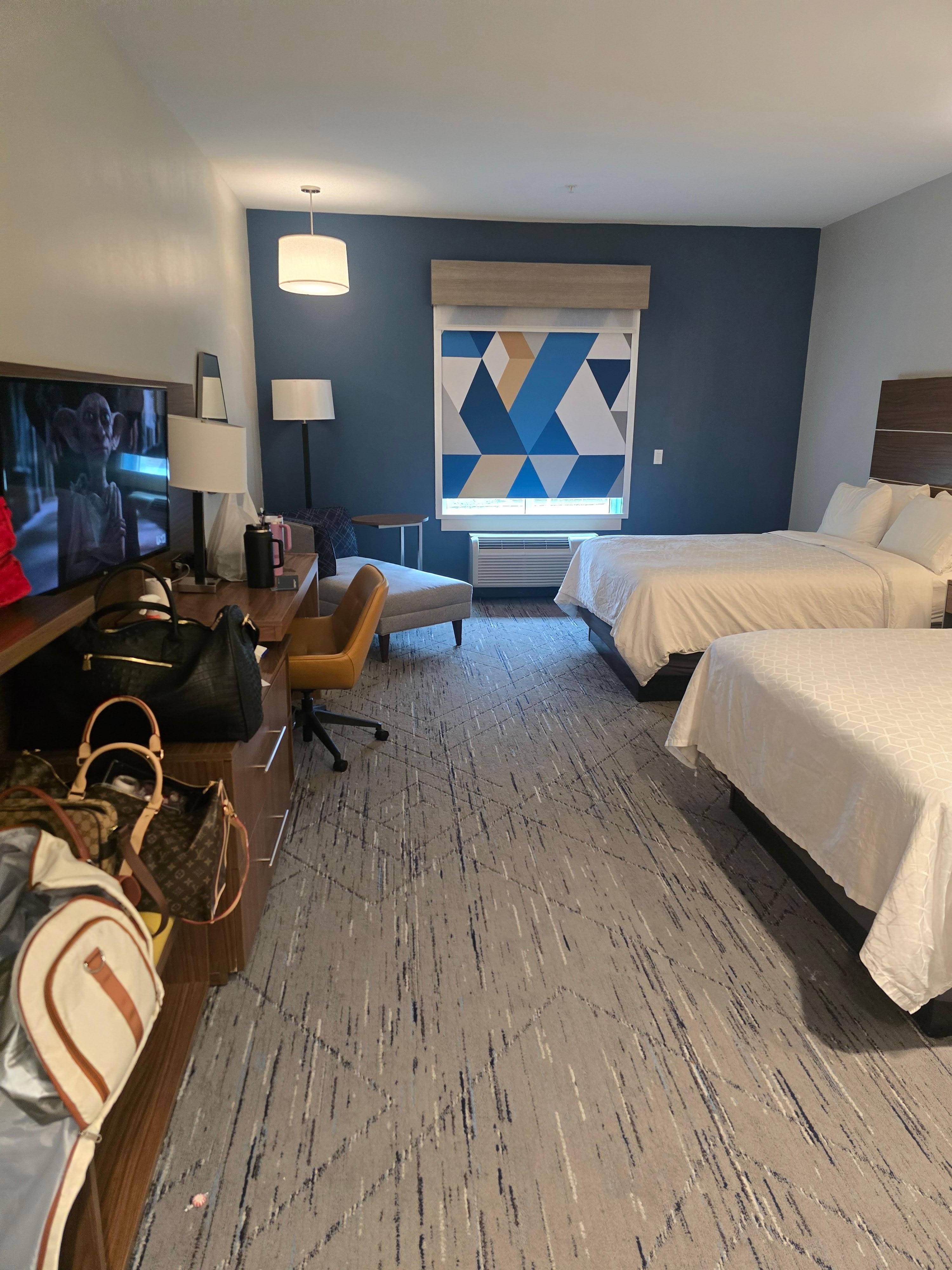 View of 2 Queen beds with lounging area and desk