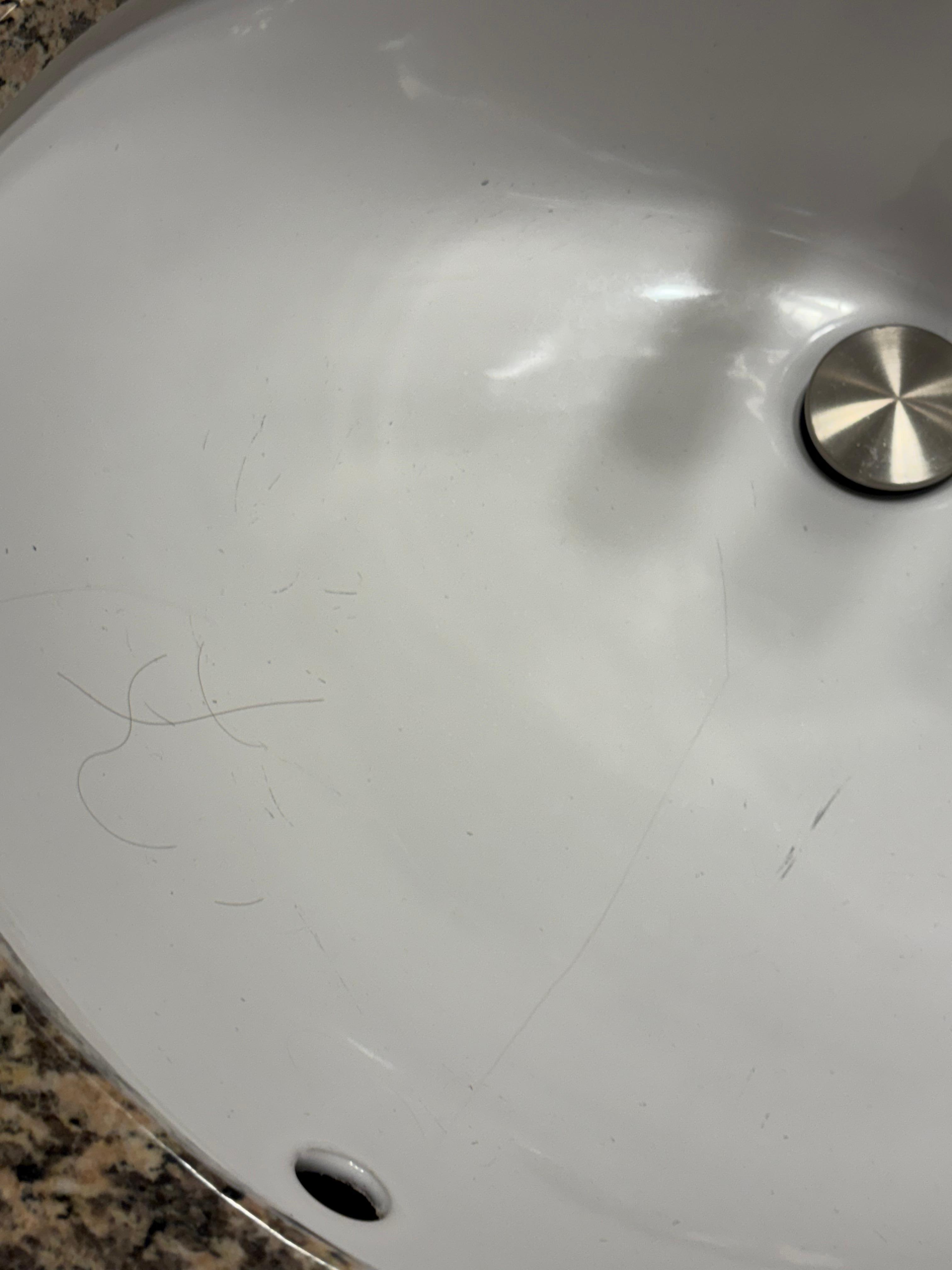 Dried up hair on the side of the sink