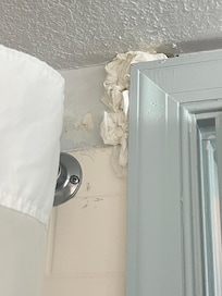 Toilet paper or paper towels at the top of the bathroom door where there was a previous leak.