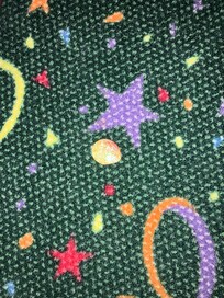 A fuzzy peach candy randomly on the floor in our room.