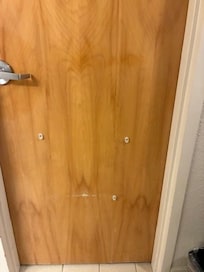 odd mirror holders left on front of bedroom door for the gross plastic mirror moved into back of the door in the bathroom