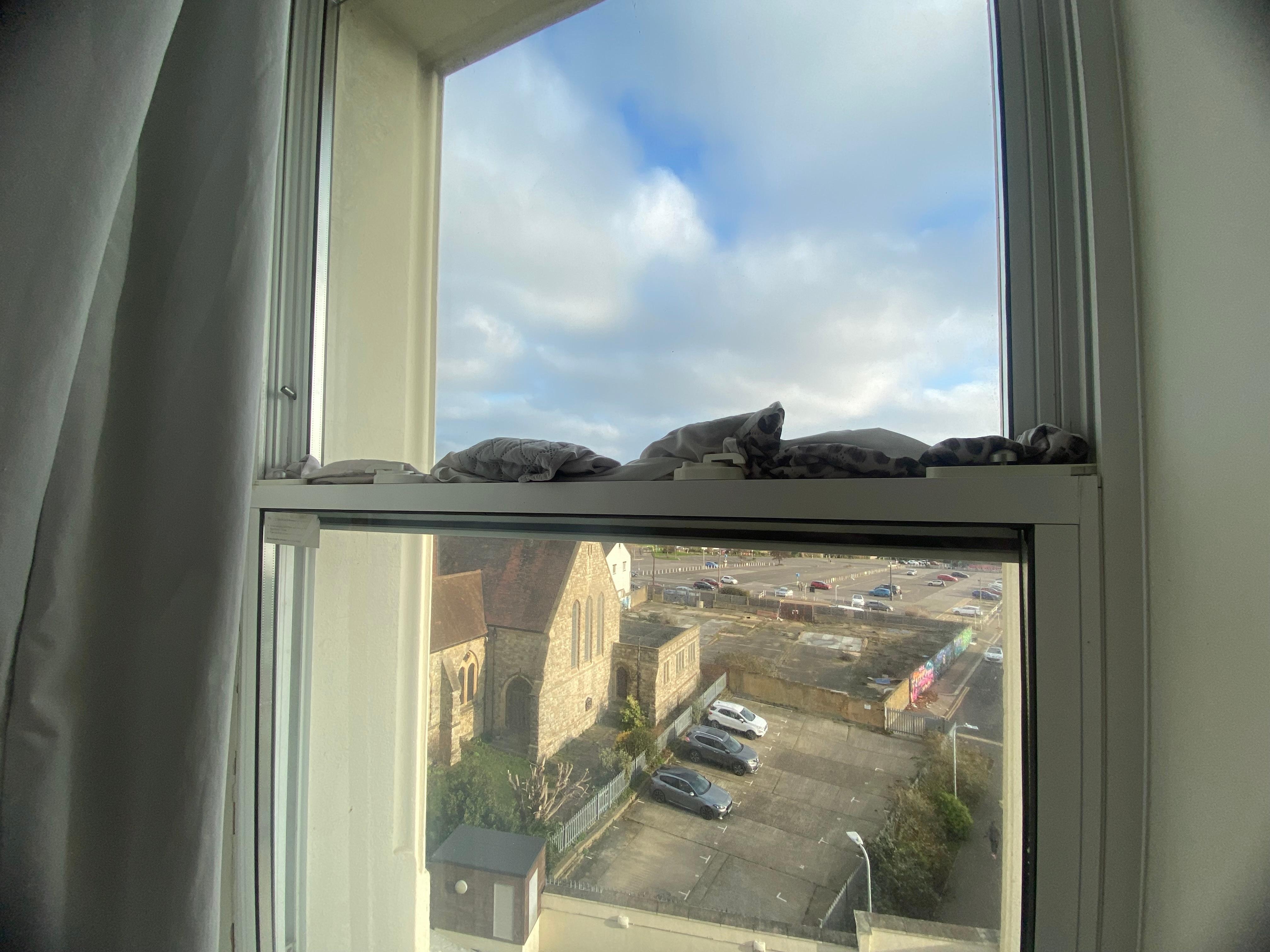 Pillowcases stuffed into window gaps to try to reduce draft. 