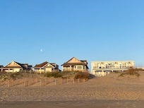 The hotel viewed from the beach is on the right.