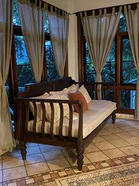 Bedroom adjoining one of several lovely outdoor porches.
