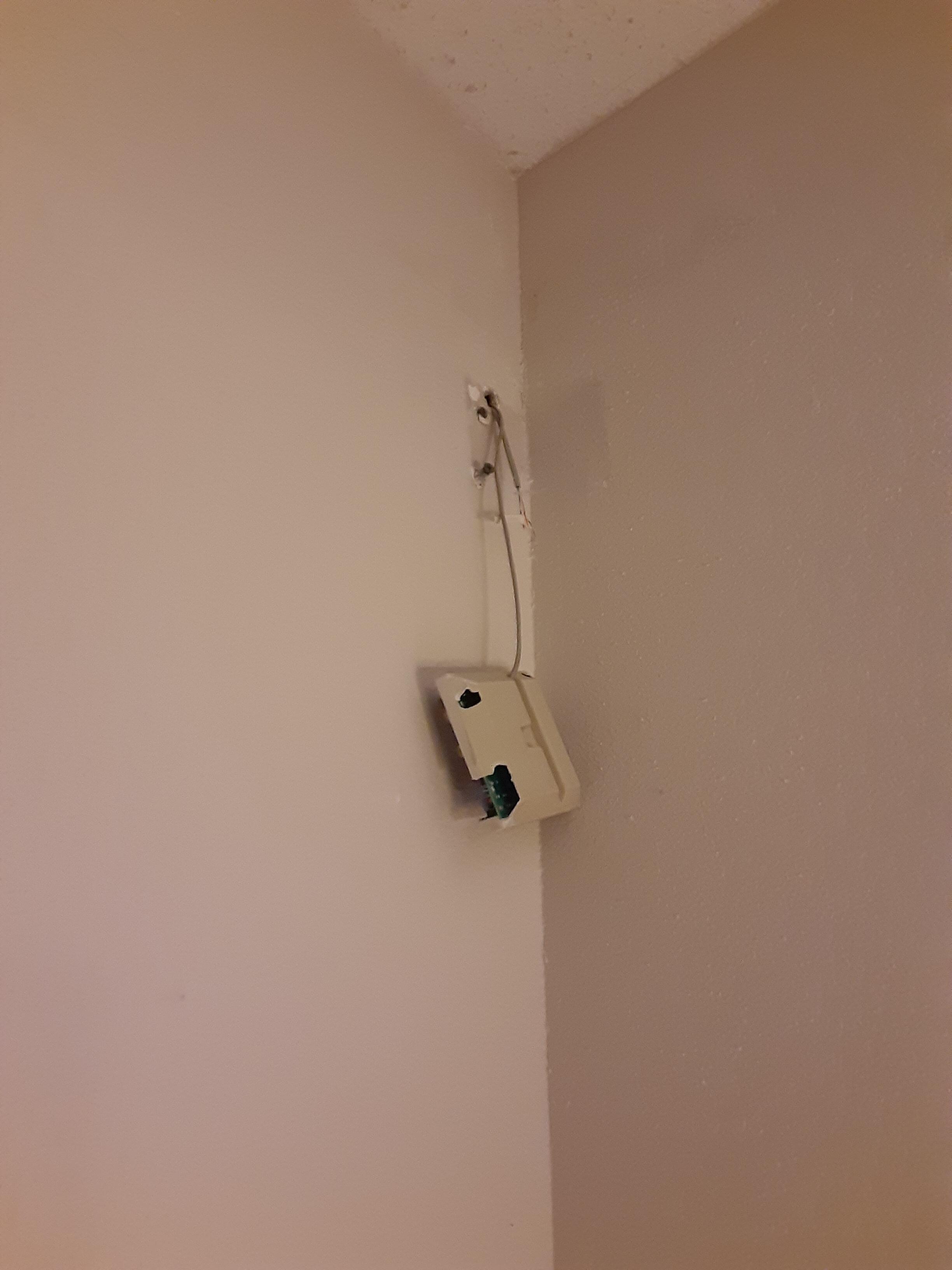 Old equipment wires hanging from wall.