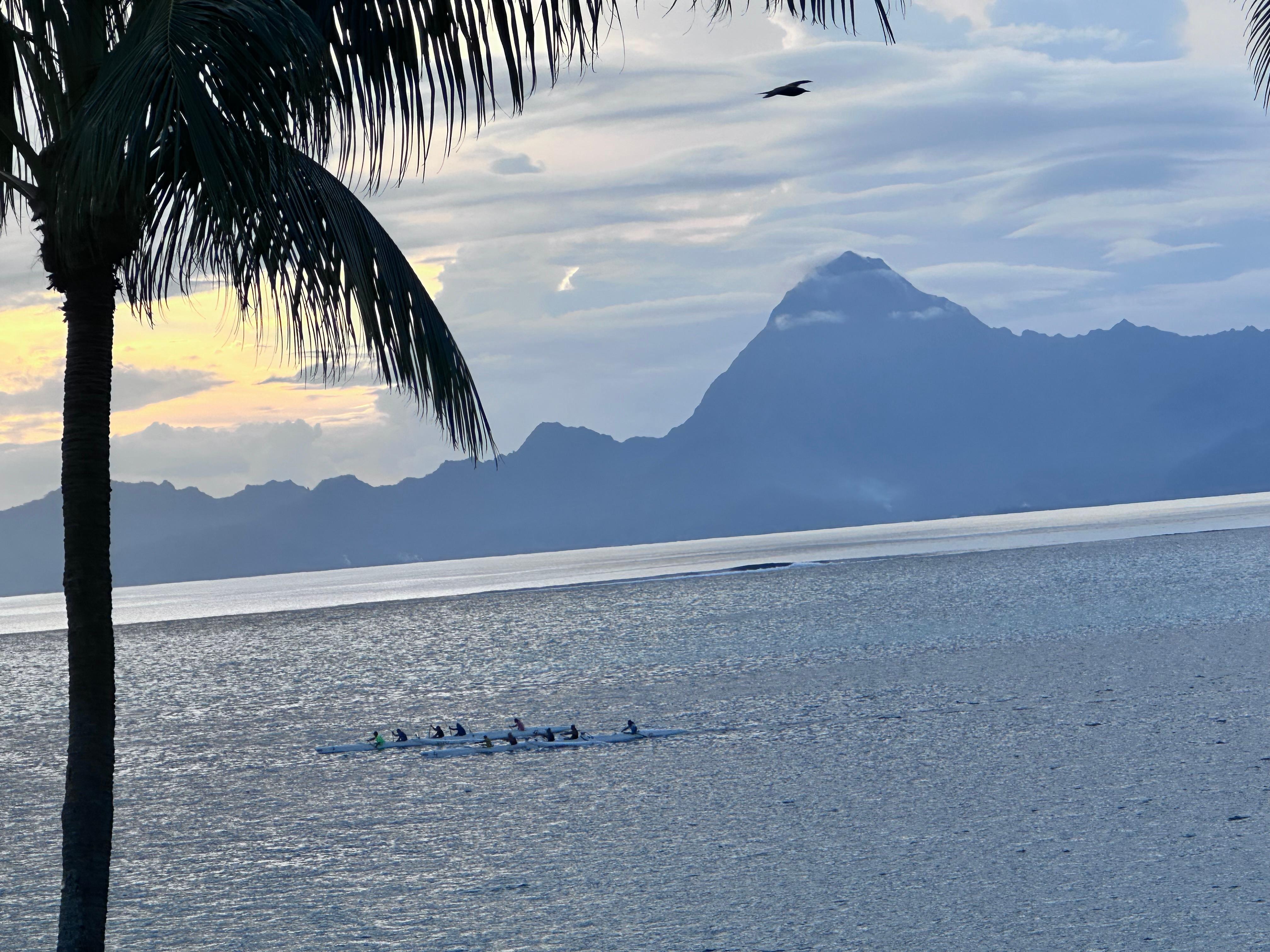View from our room balcony towards sunset watching longboats glide by