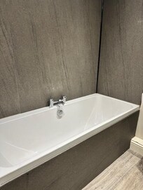 Separate bath in bathroom