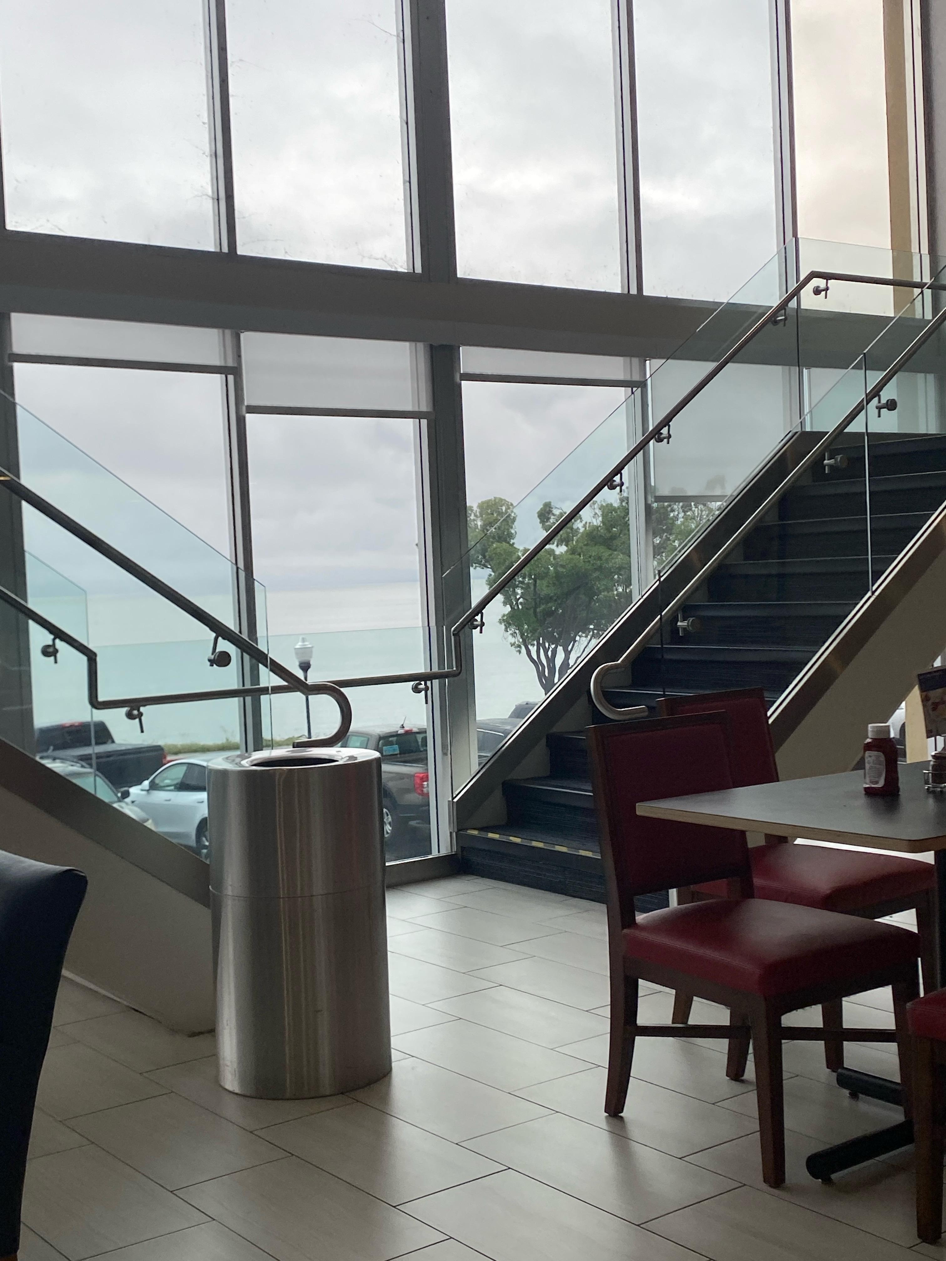 Upper seating for breakfast with bay and airport view.