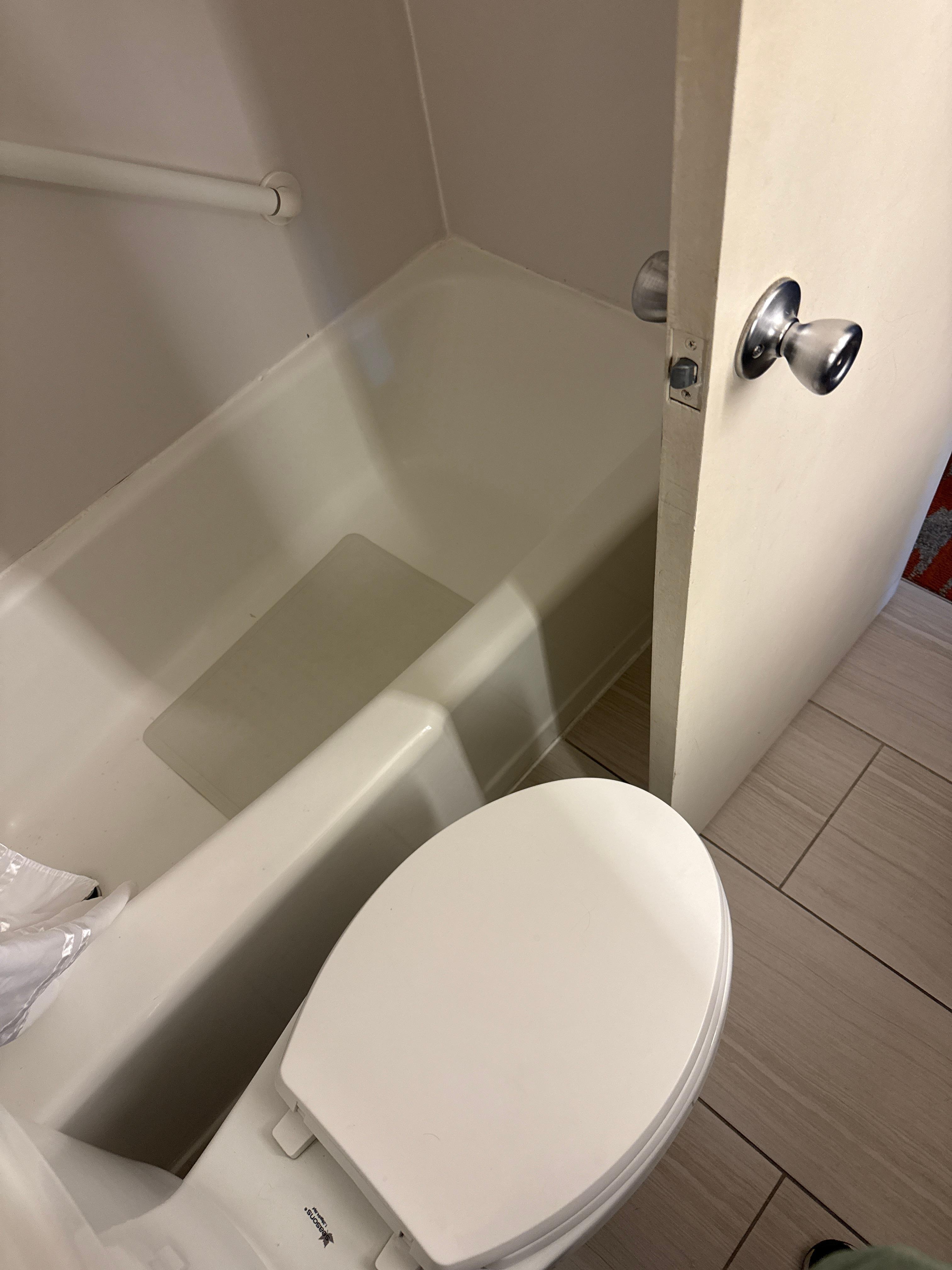 The bathroom was so small that you had to walk all the way in before you could close the door so you could sit down on the toilet. 