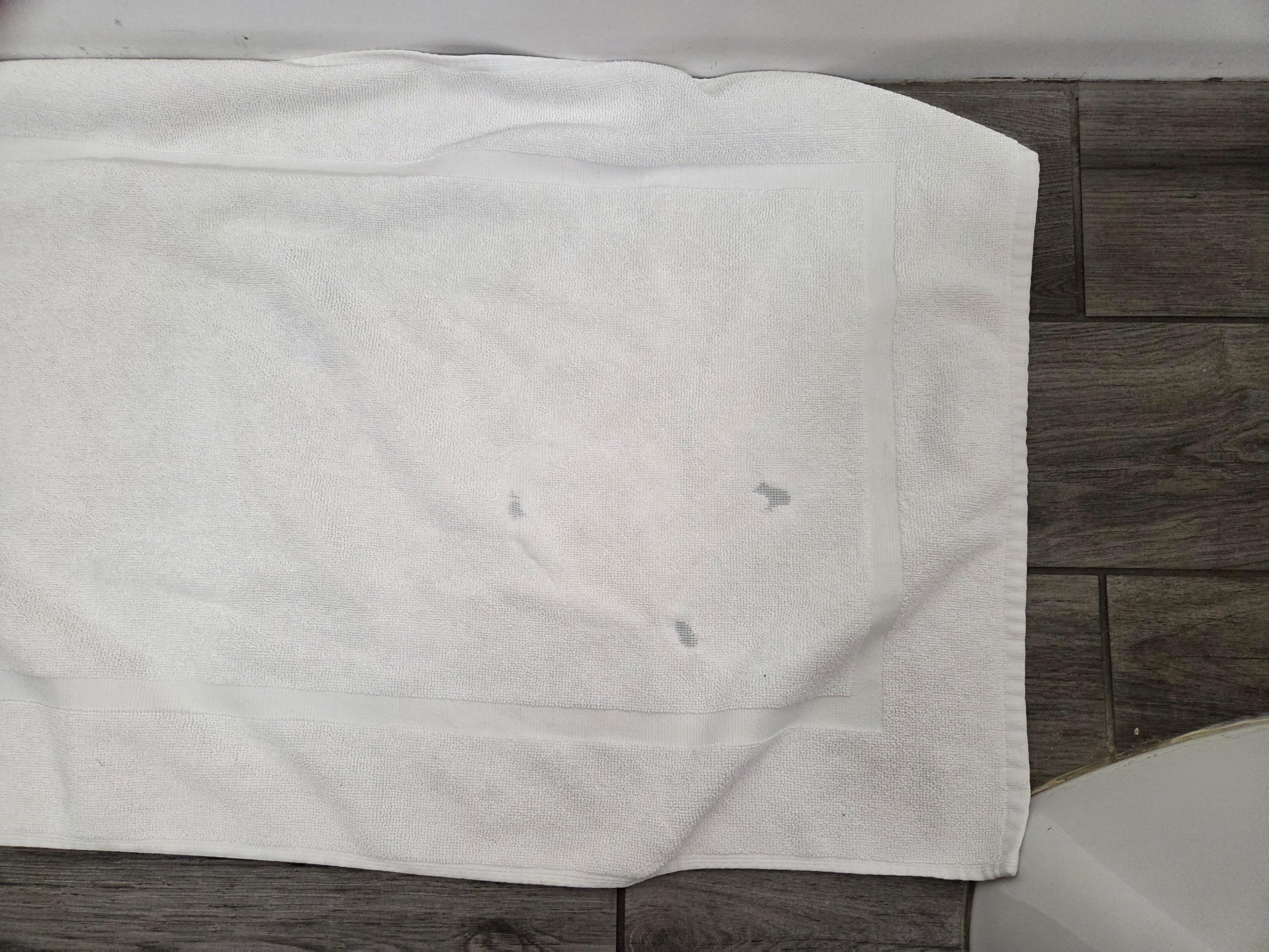 Hole in bath mat.