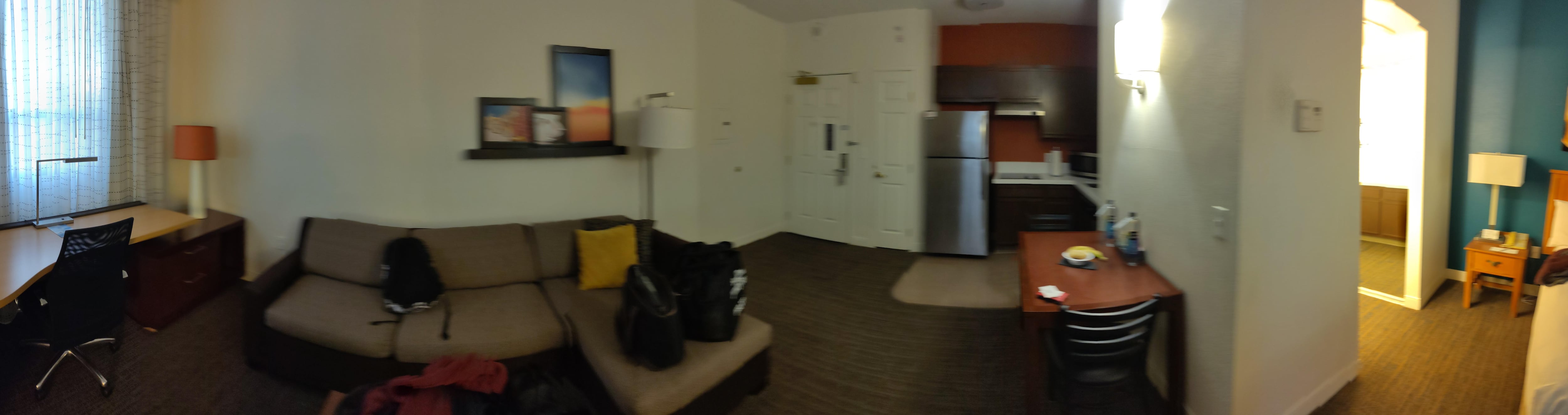 Sofa, Tv swivals from sofa towards the bed. Stove, frig, dishwasher, dishes.