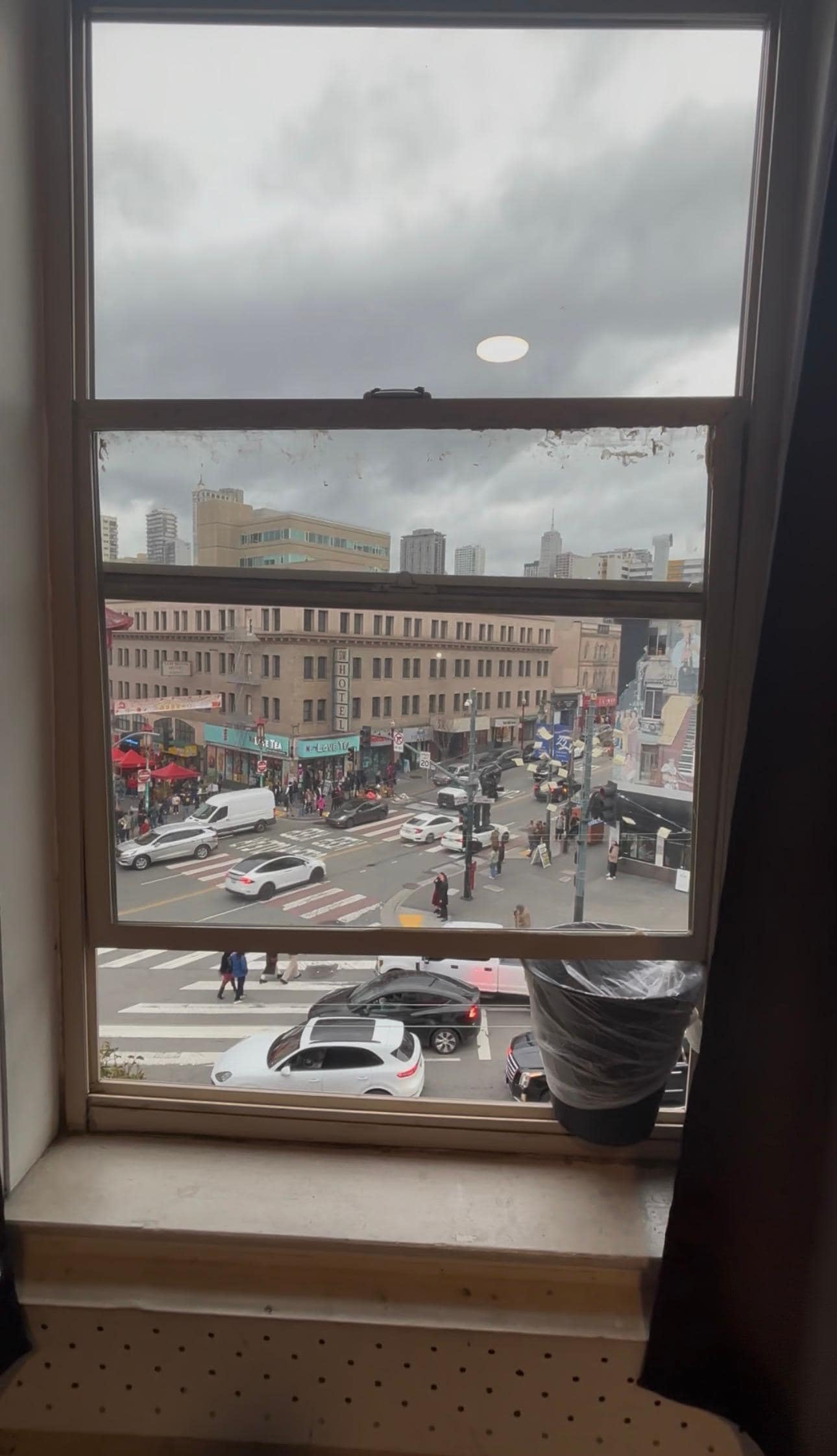 Window being propped up with trash can 