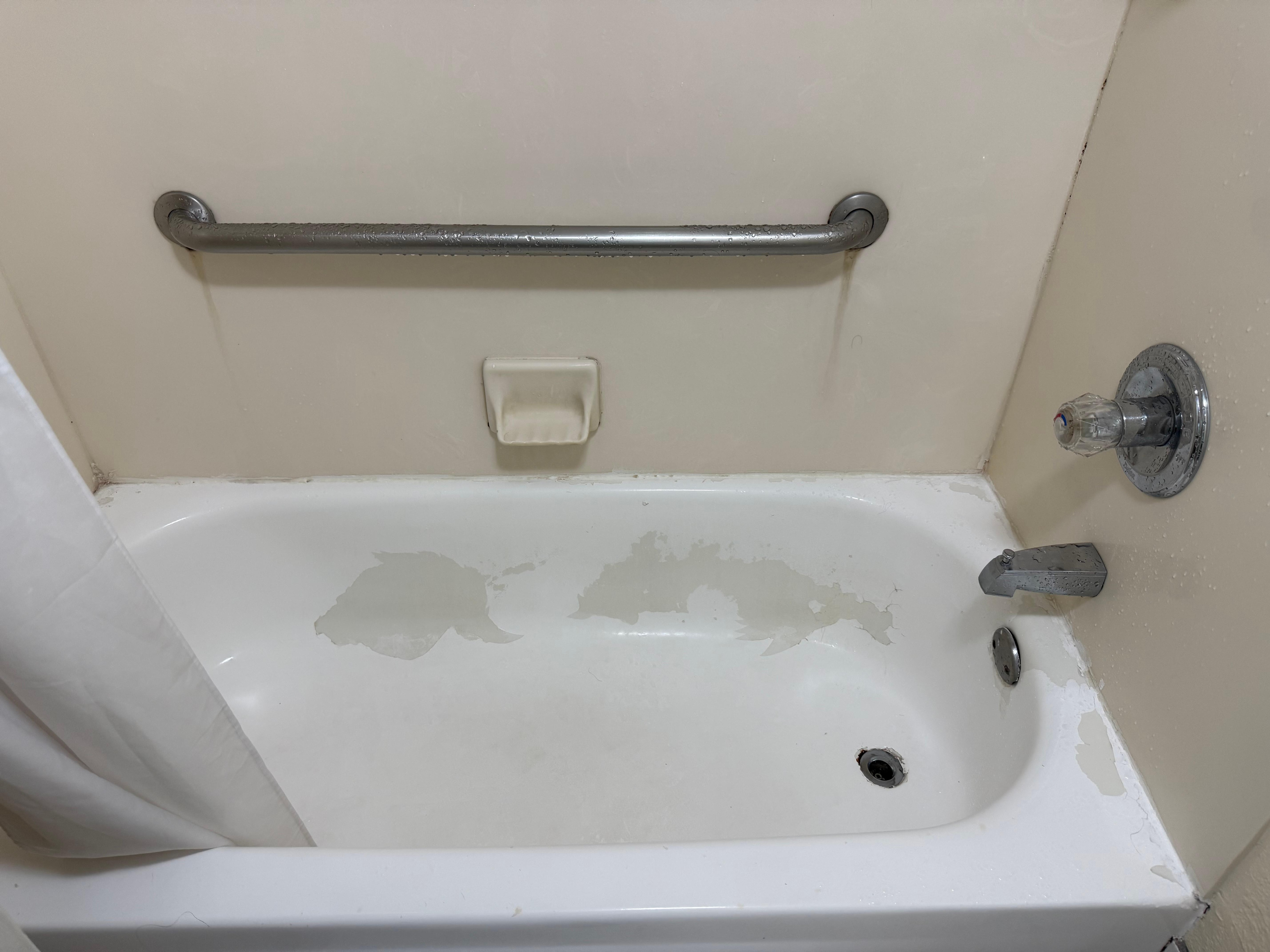 This is the tub. Peeling and black around edges in places.water pressure was fine. 