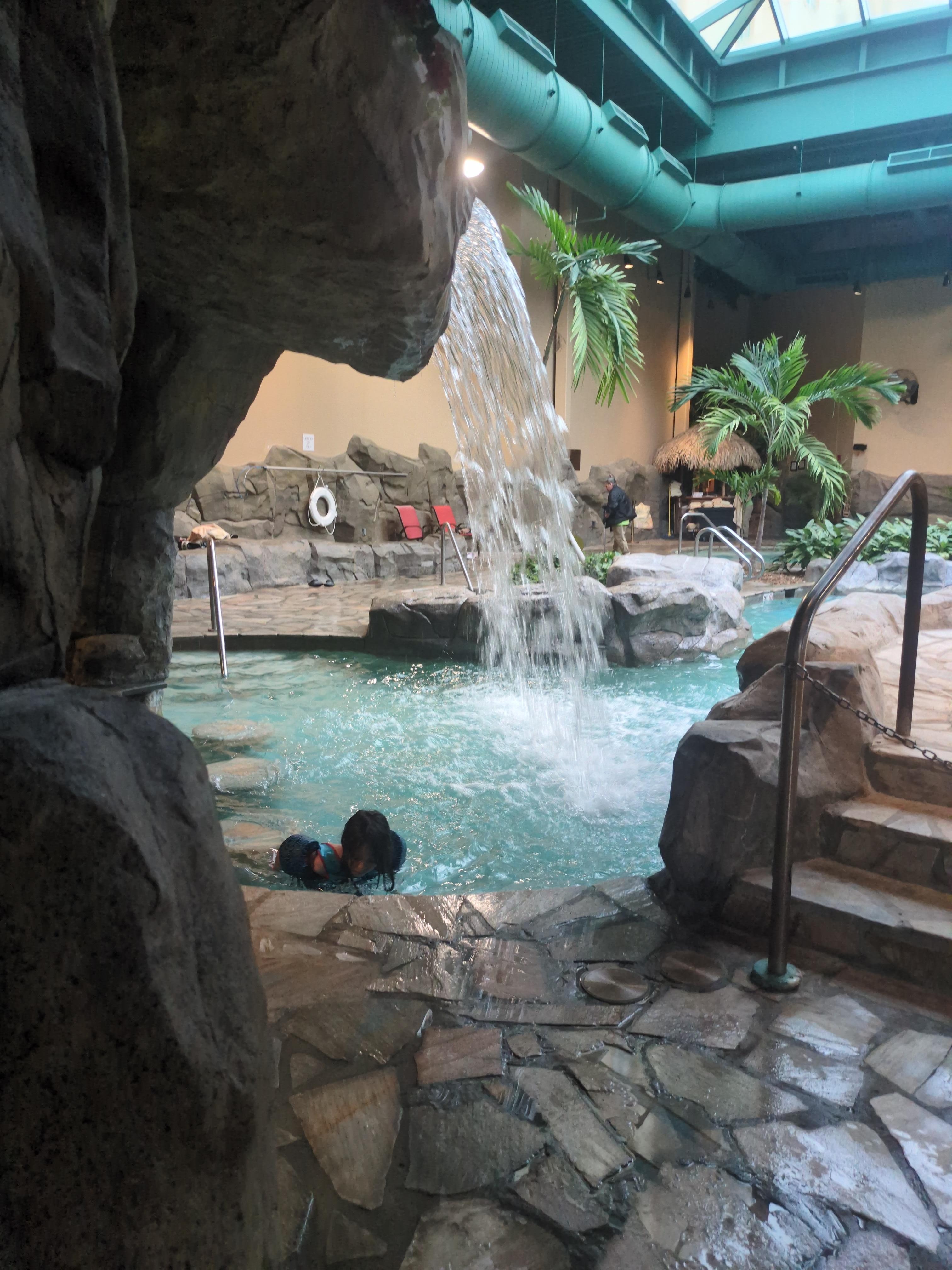 My kid is swimming in a gorgeous indoor pool. It was raining outside but we still had fun !