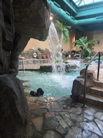 My kid is swimming in a gorgeous indoor pool. It was raining outside but we still had fun !