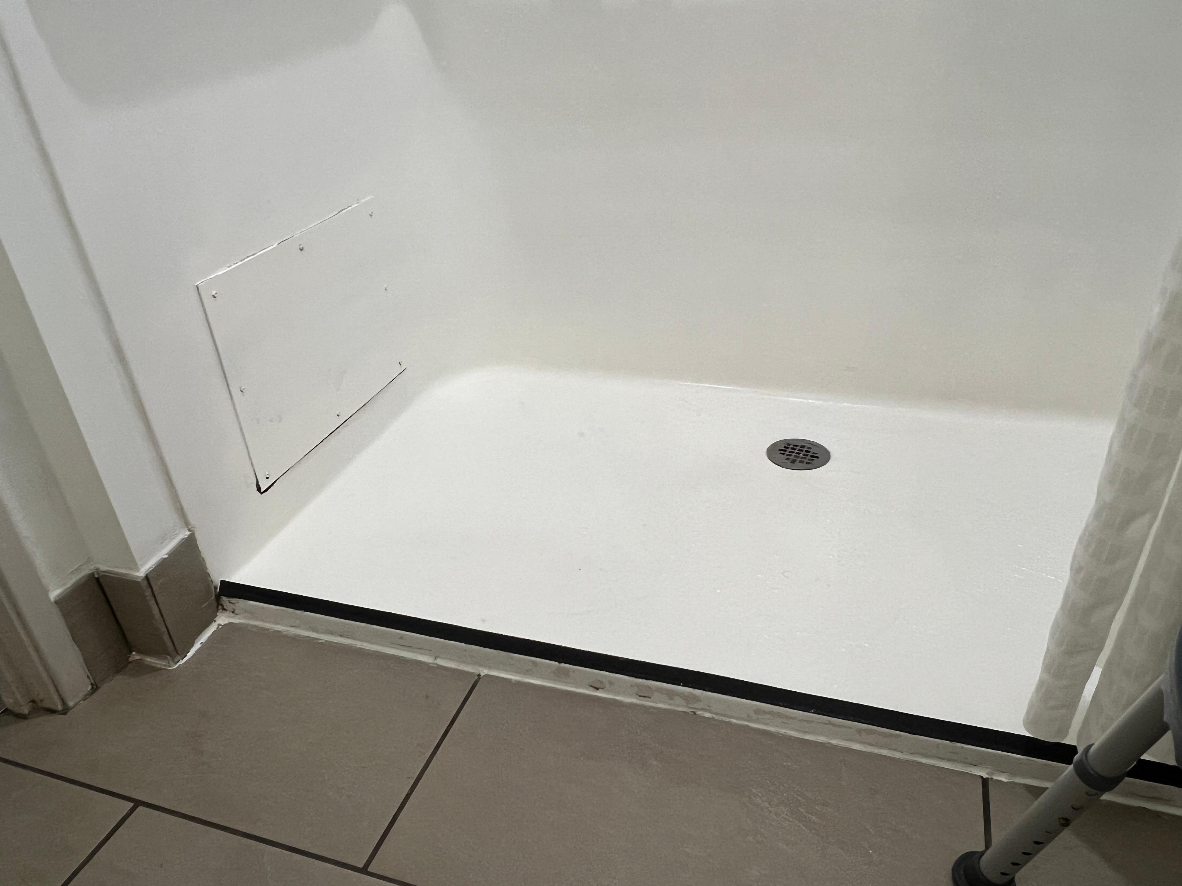 Hairs and stains in the shower and on the floor. Access panel that doesn’t look like it belongs there. 
