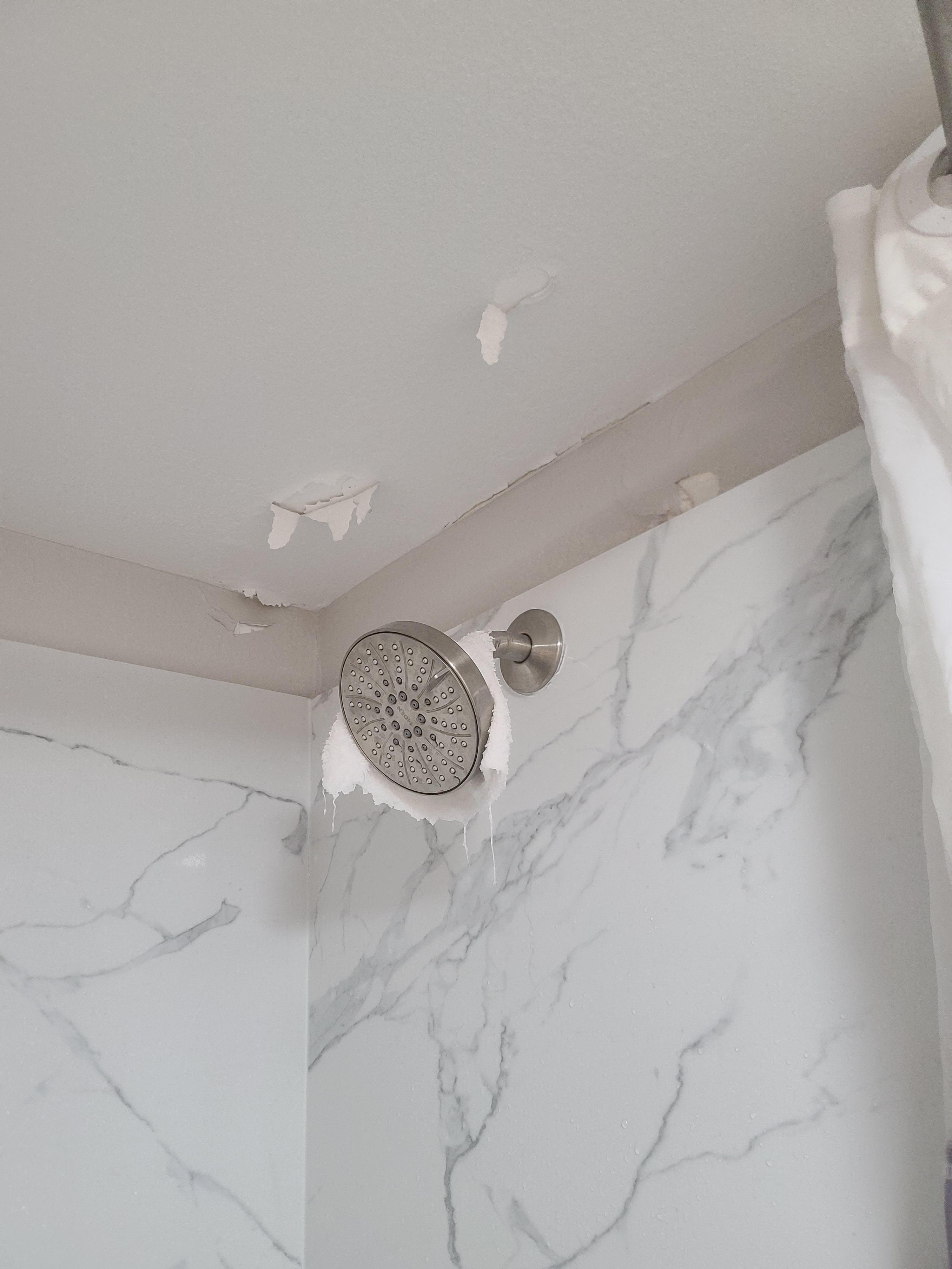 A shower was wrapped with a cloth.Only got there to keep it from spraying.All over the room.You can see the paint peeling off the ceiling