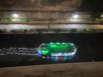 A river pontoon boat going by directly down from my window overlooking the river