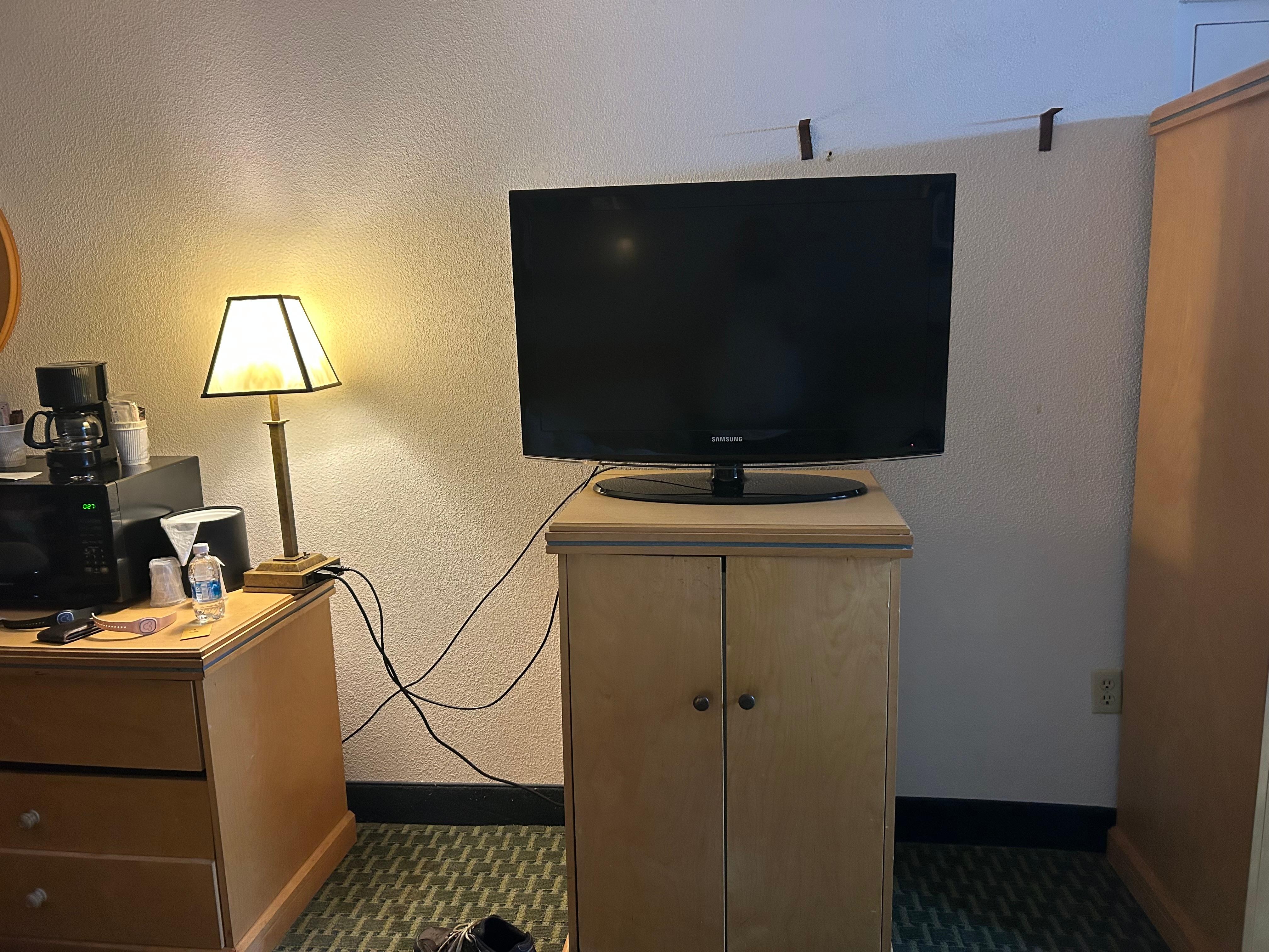 Tv on top of cabinet with lamp and cords from one cabinet to another. Good thing we didn’t have young children.