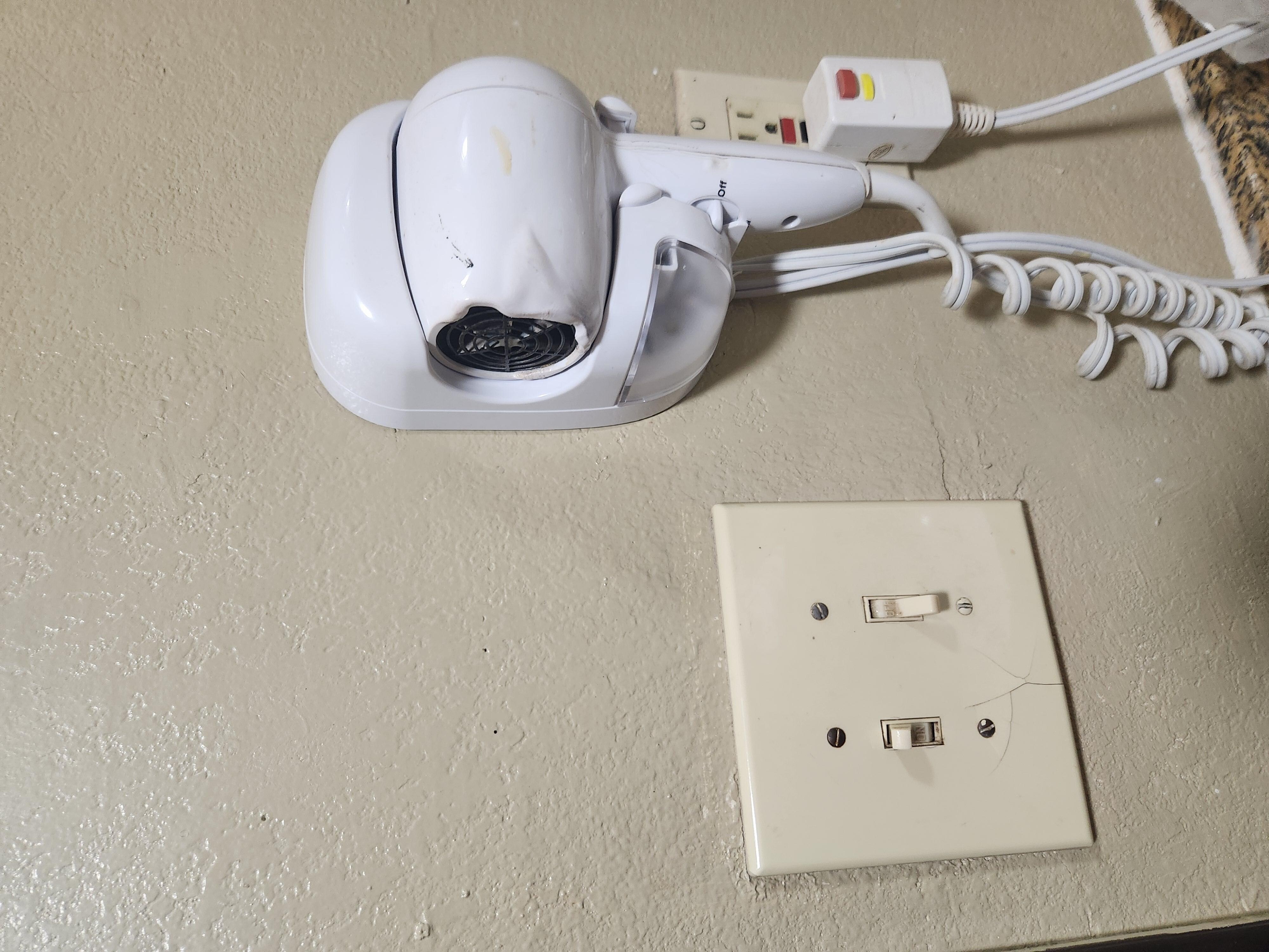 Melted hair dryer and nasty wall