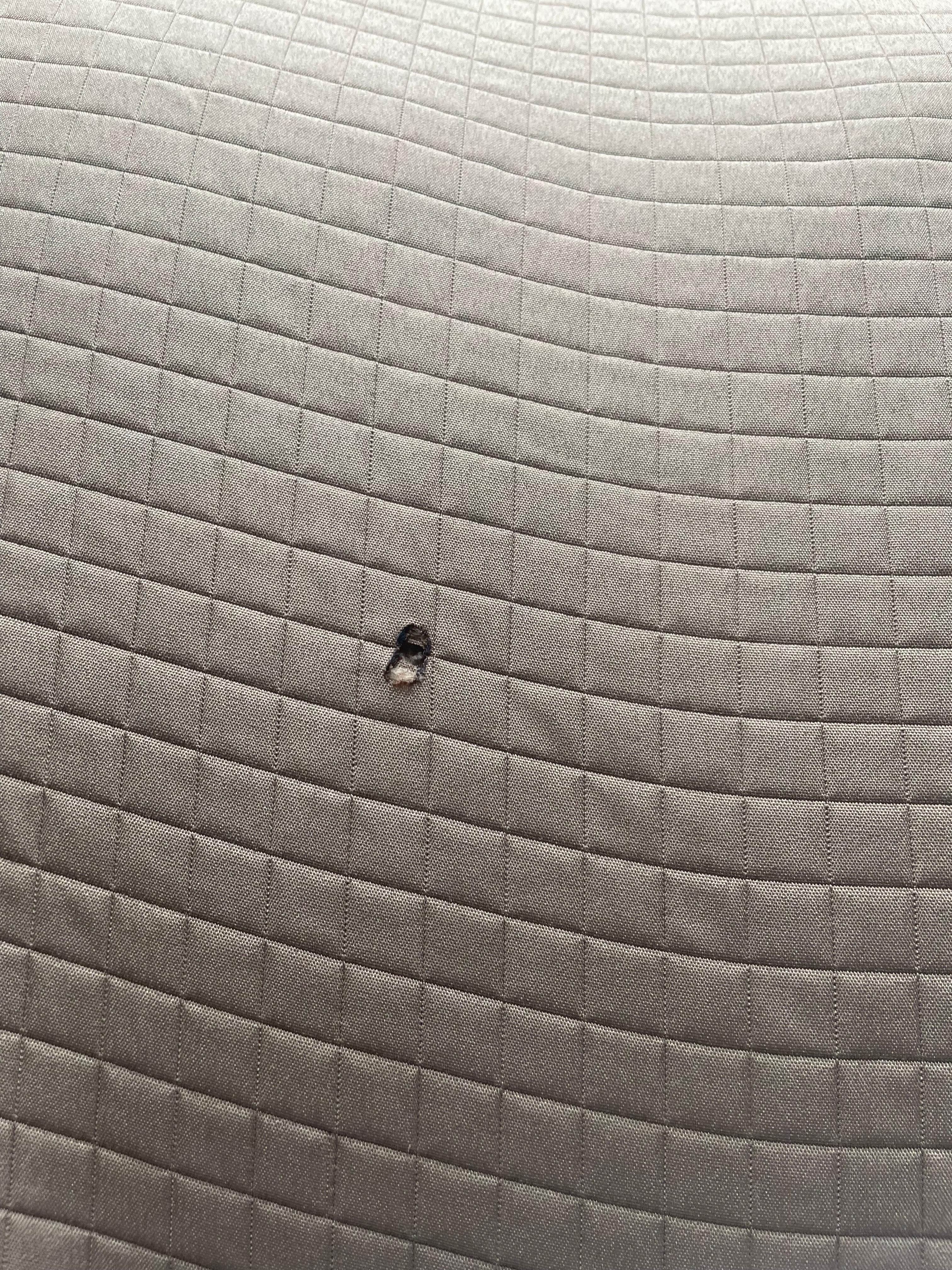 Cigarette hole in bedspread