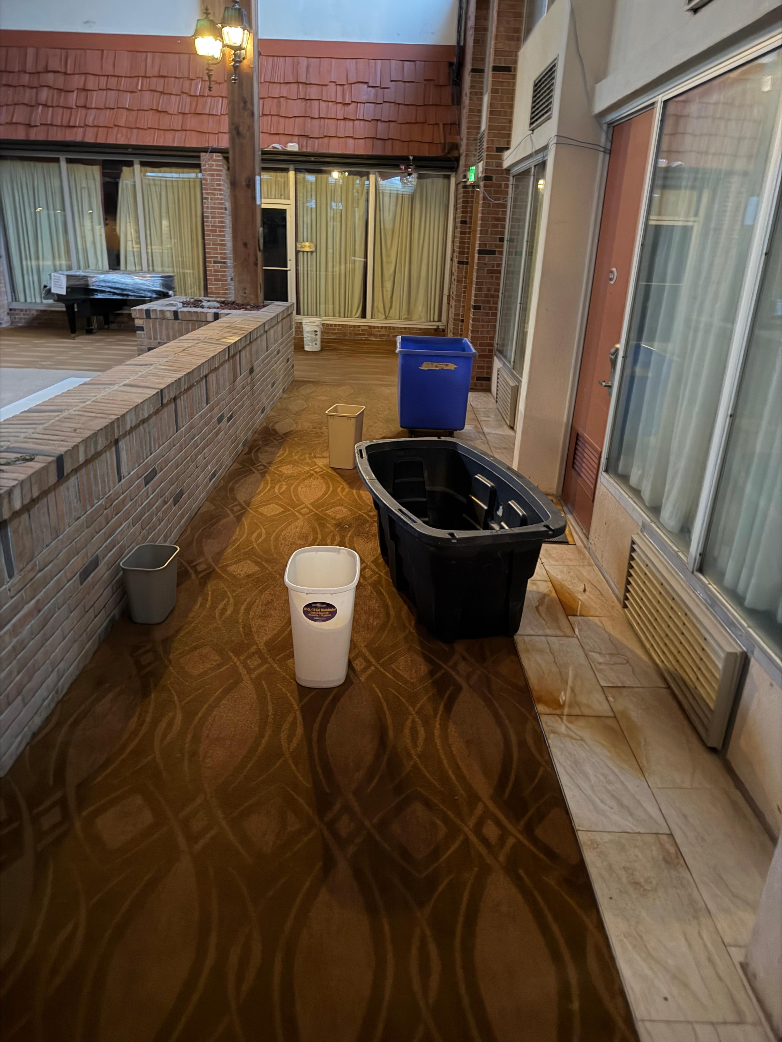 This was the hallway catching water dripping from the ceiling- no caution signs