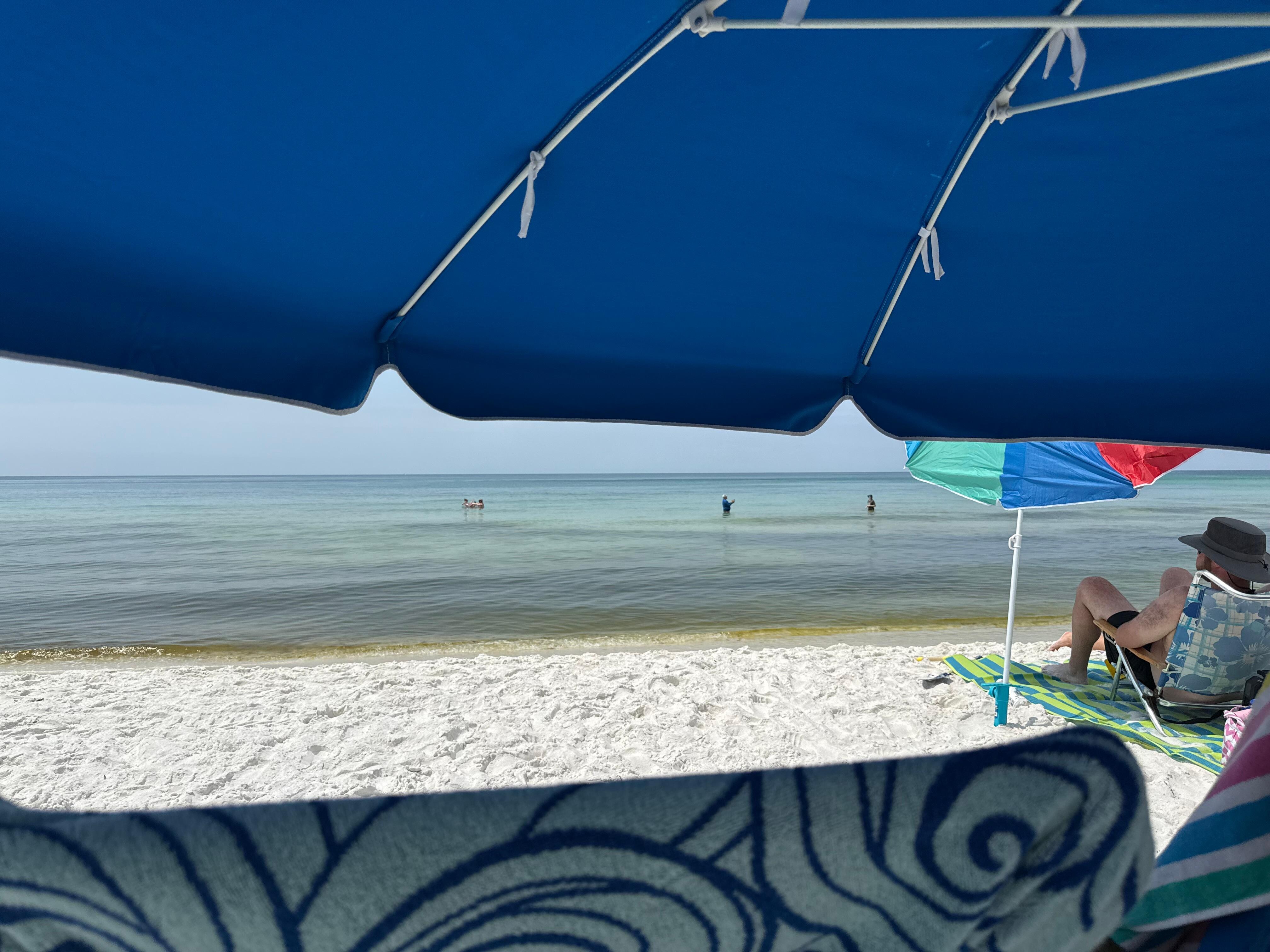 Beach right outside the condo while under the rental umbrella and chairs