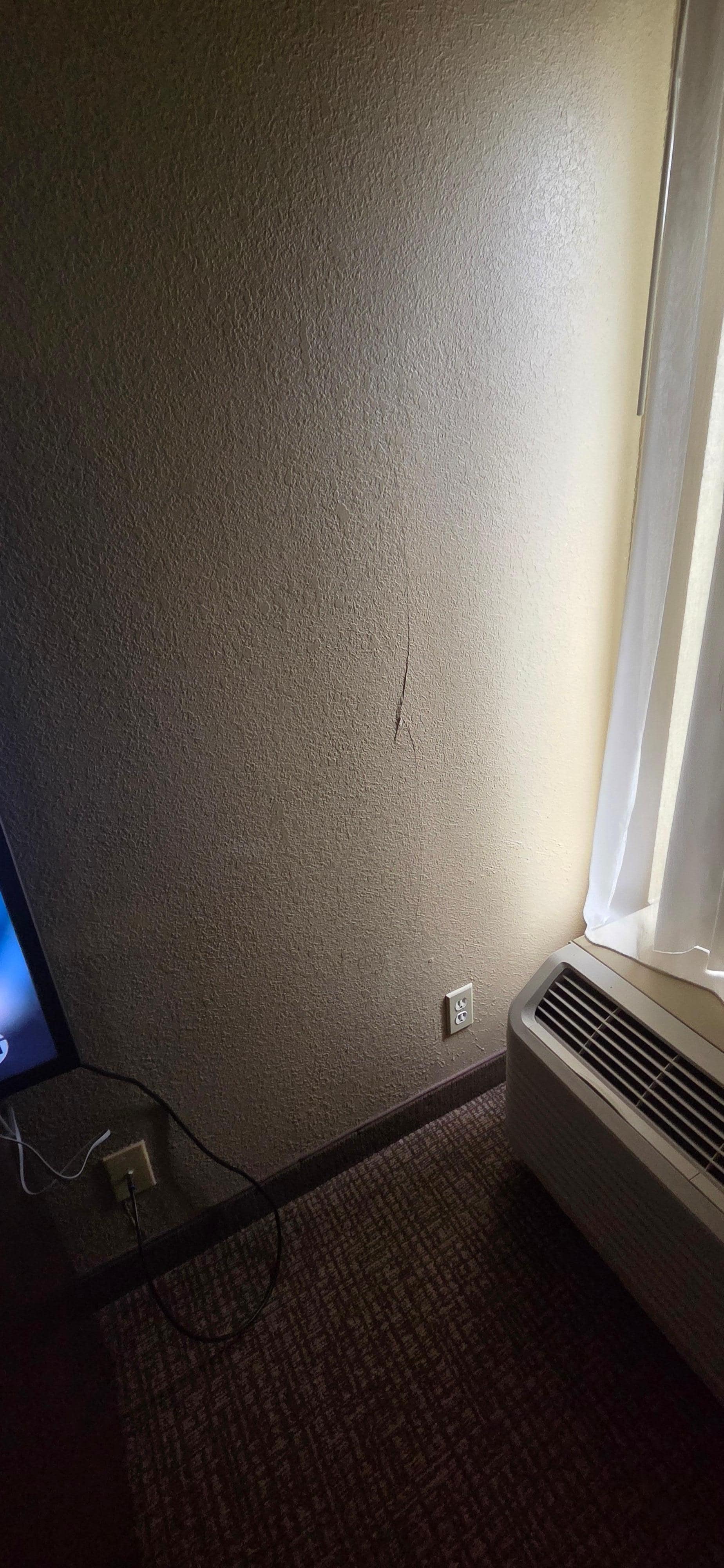 Crack in wall by air conditioner 