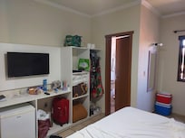 Porta do banheiro, televisão, armários, frigobar.