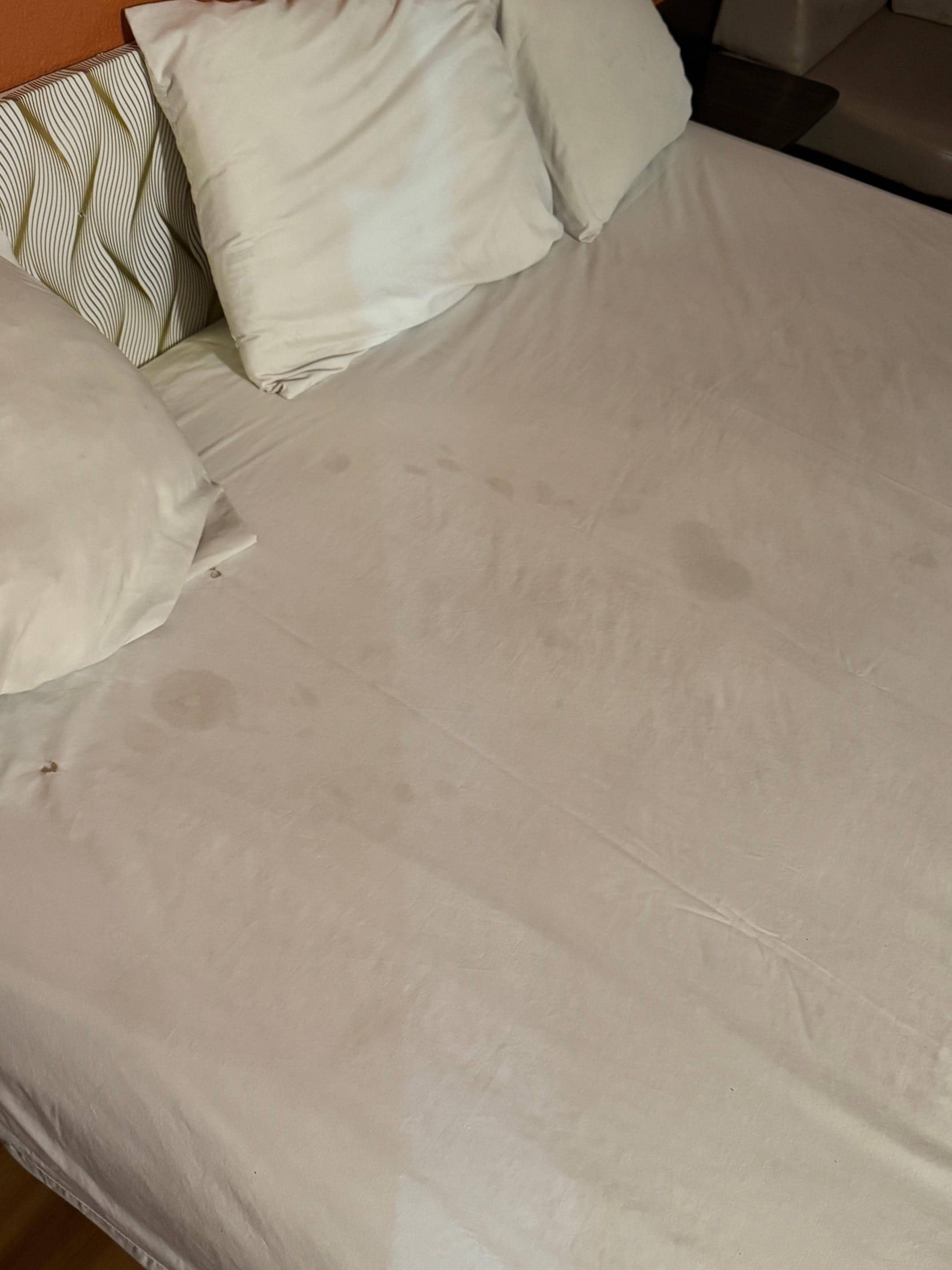 stains and cigarette burns on the sheets